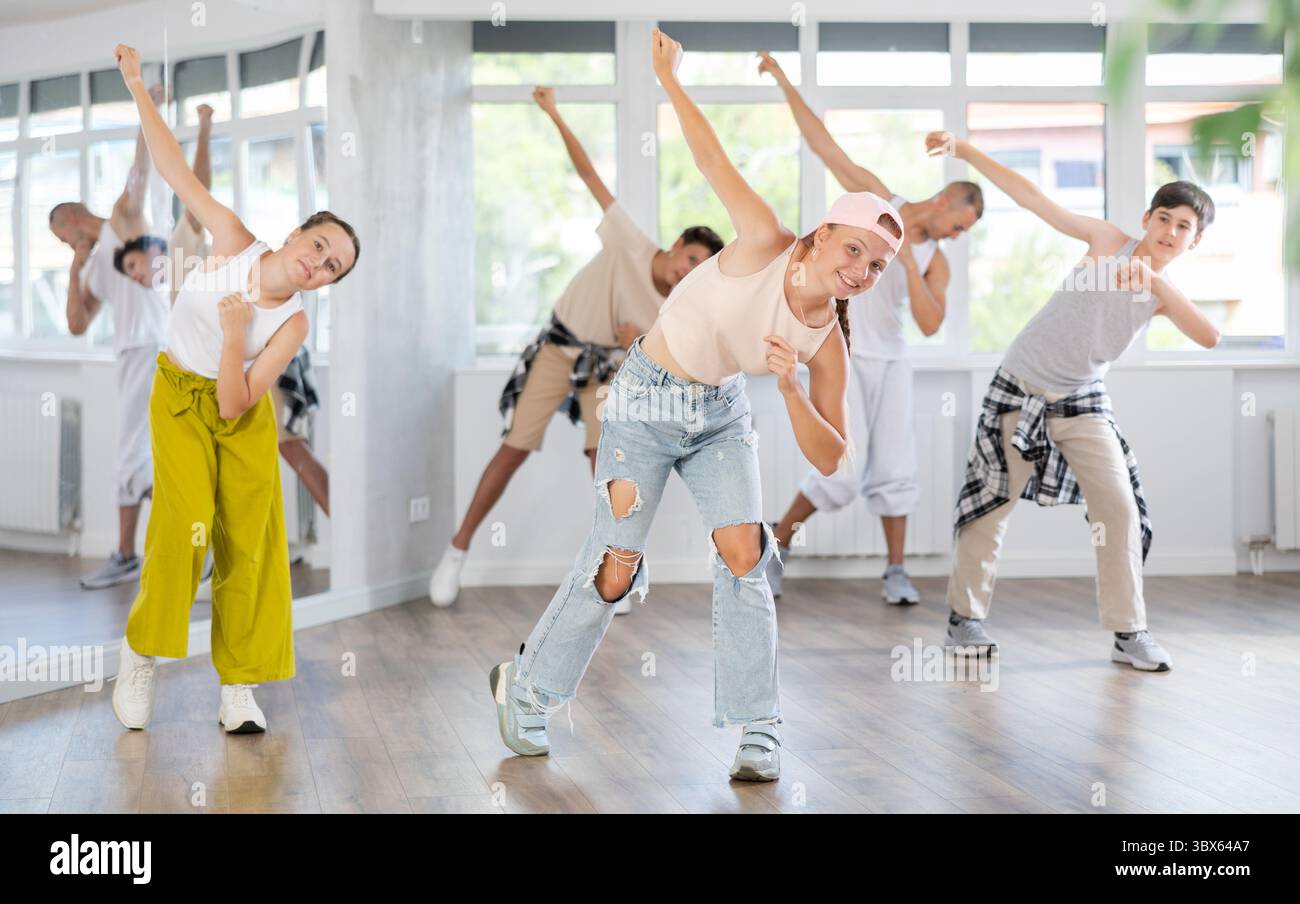 Teenage girl practicing hip hop slide moves in training hall Stock ...