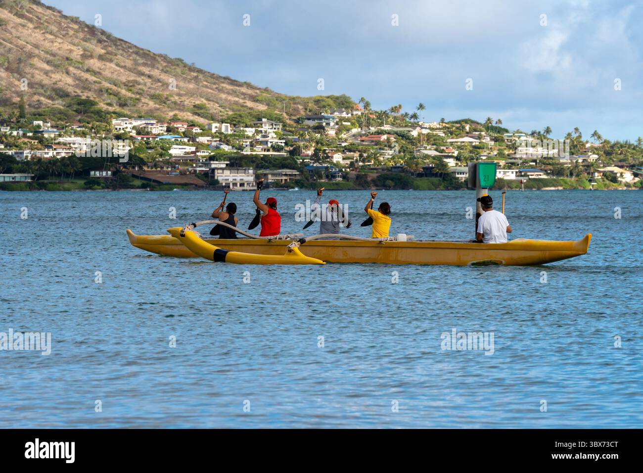 Six women navigate a traditional canoe through Hawaii’s Maunalua Bay ...