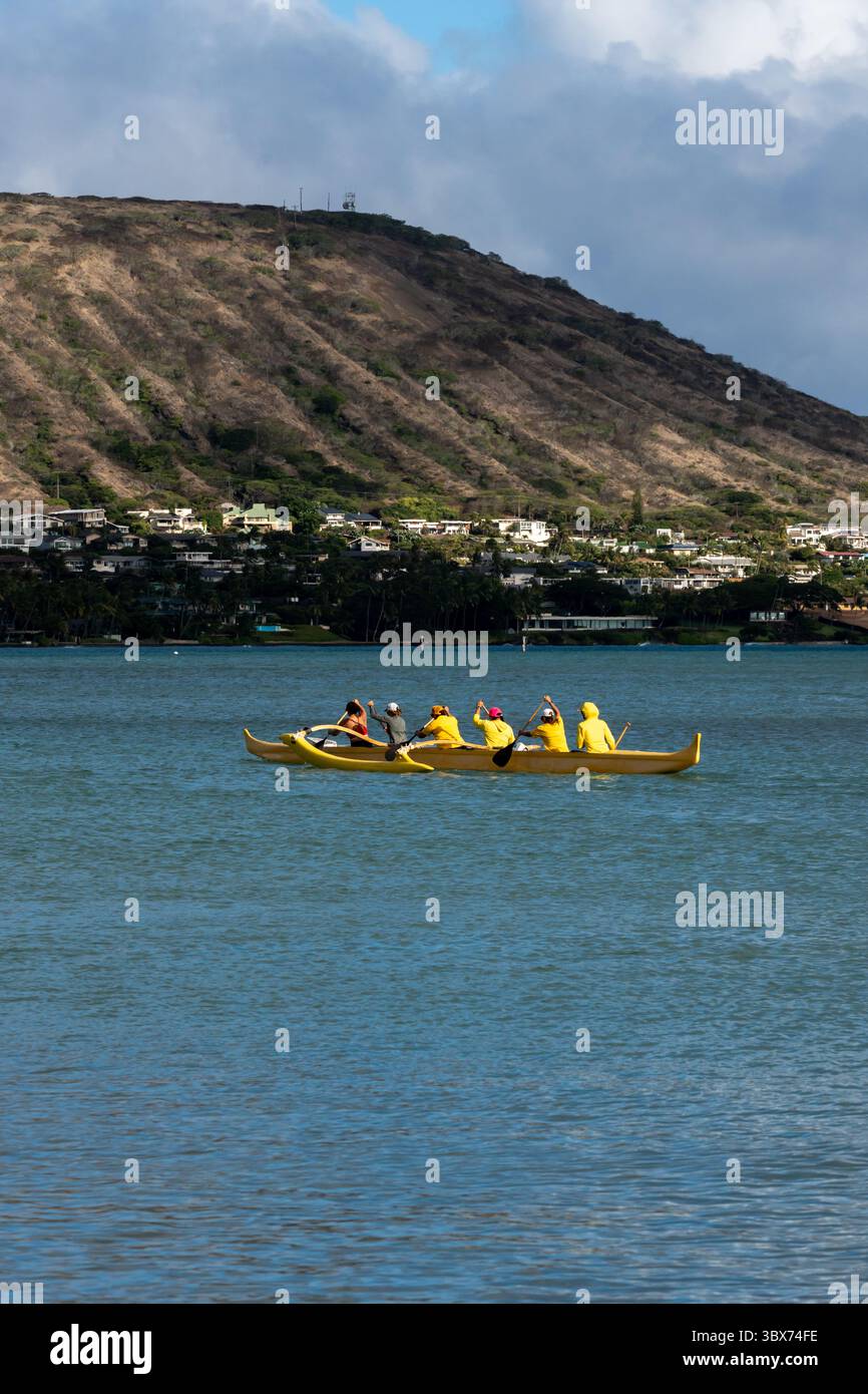 Six women navigate a traditional canoe through Hawaii’s Maunalua Bay ...