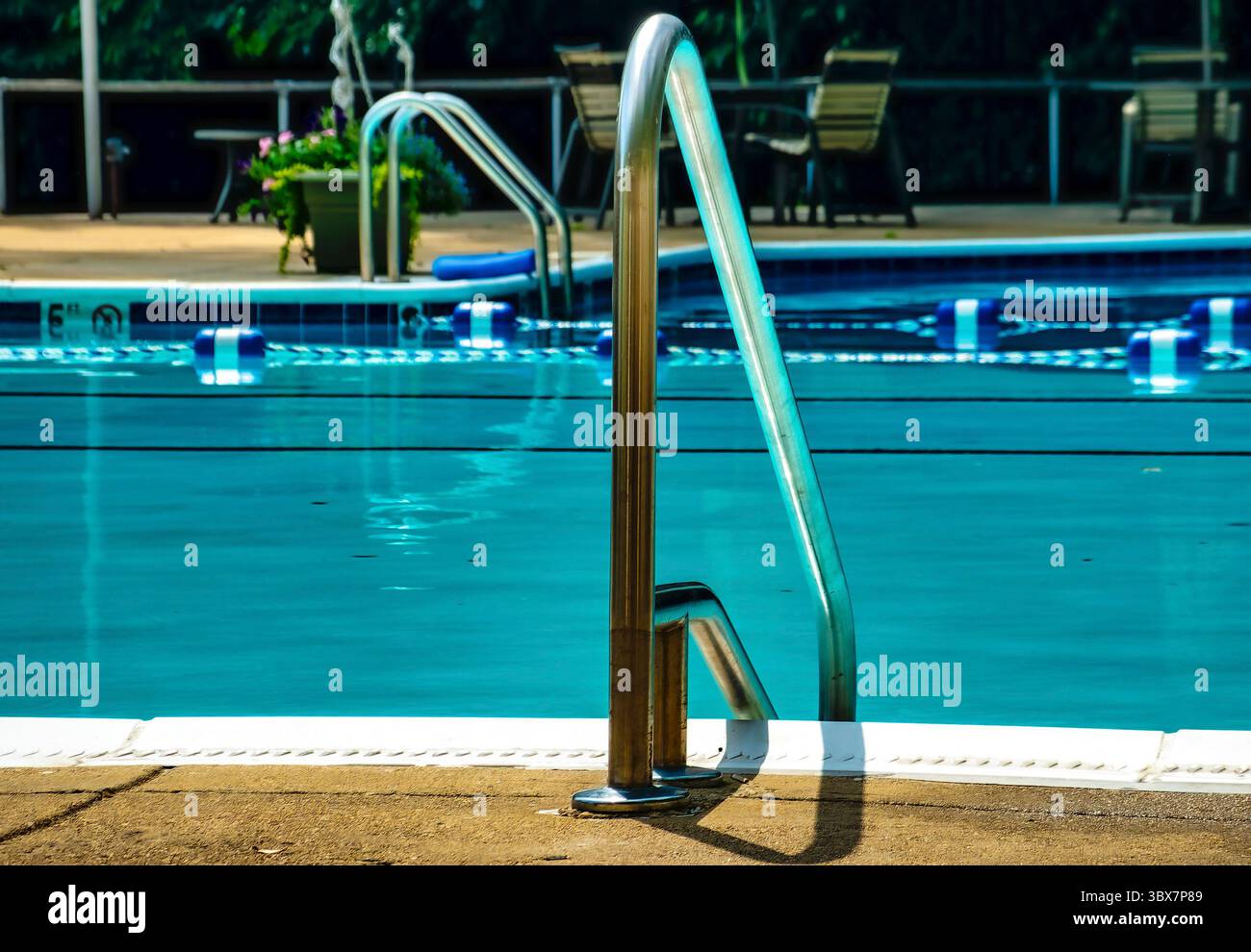 Metal railings leading to steps down to the swimming pool Stock Photo ...
