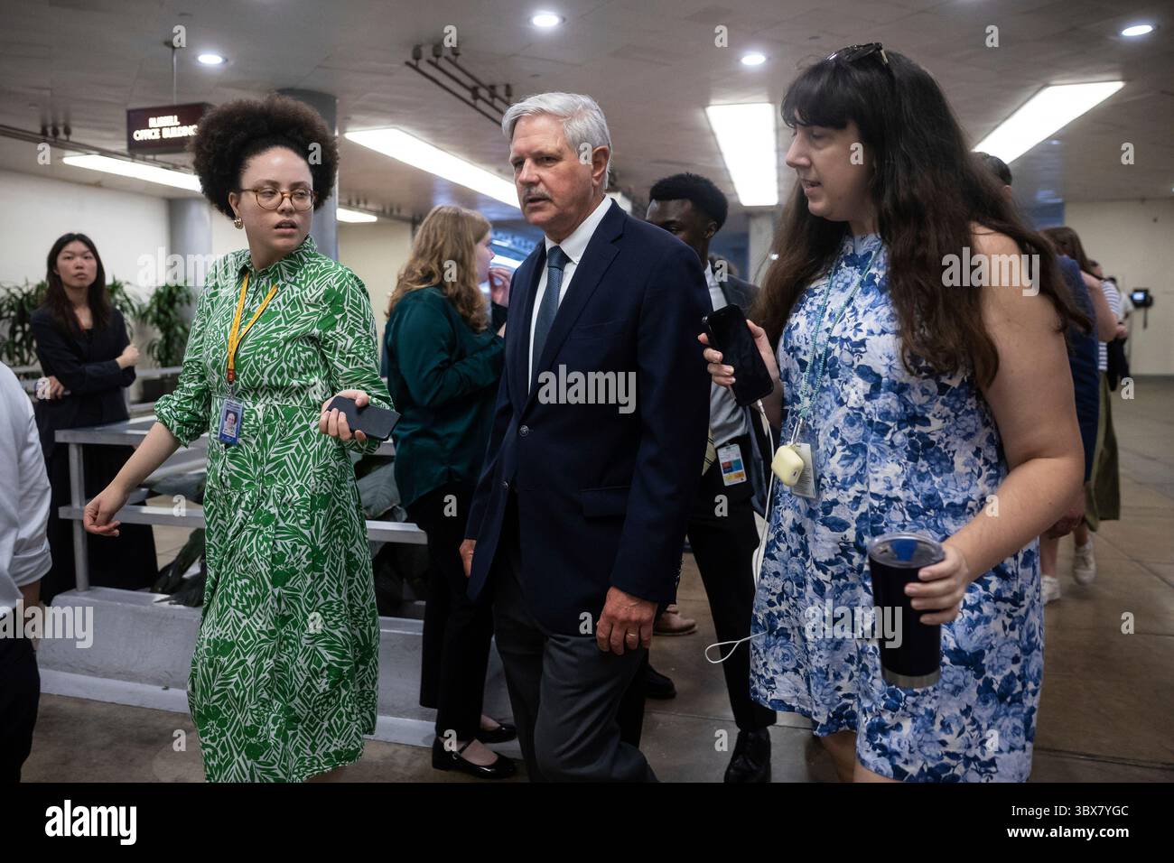 Sen. John Hoeven (R-N.D.) speaks with reporters as he walks to a vote ...