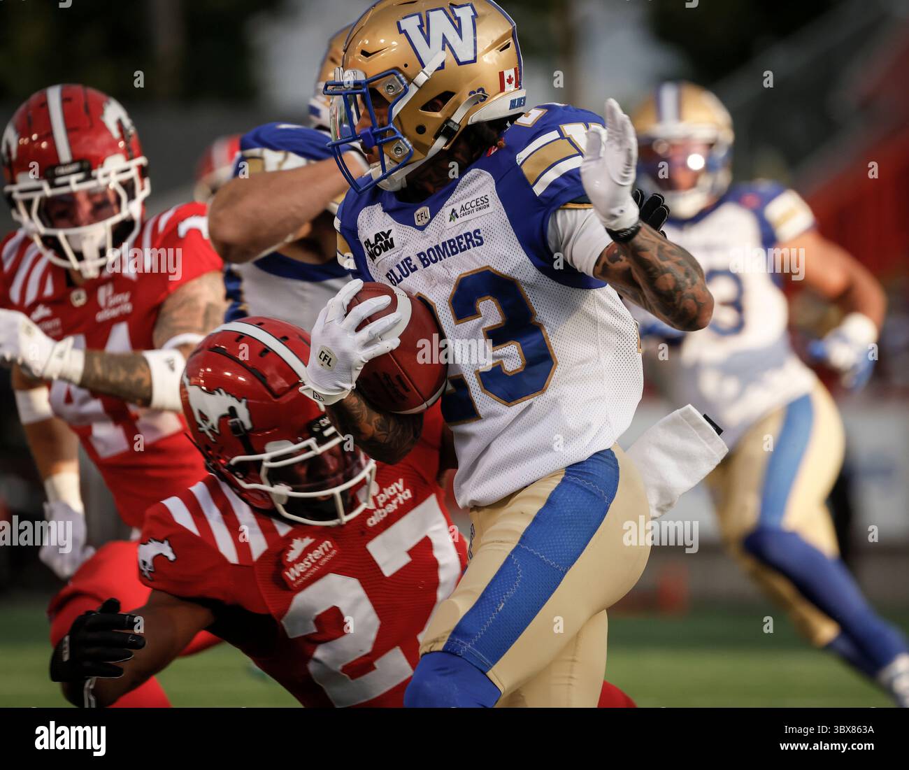 Winnipeg Blue Bombers returner Trey Vaval, right, runs the ball as ...