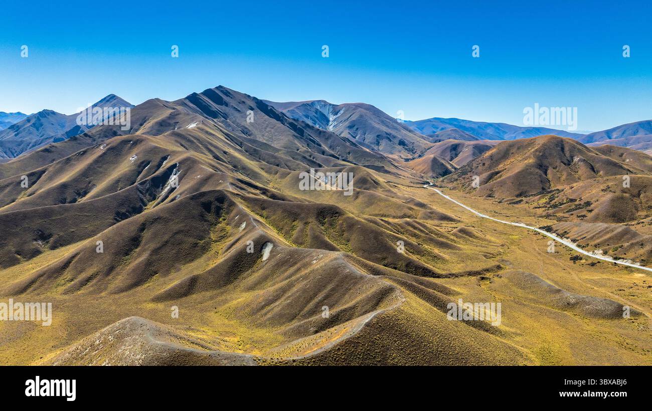 Aerial view of the alpine pass road winding its way through the arid ...