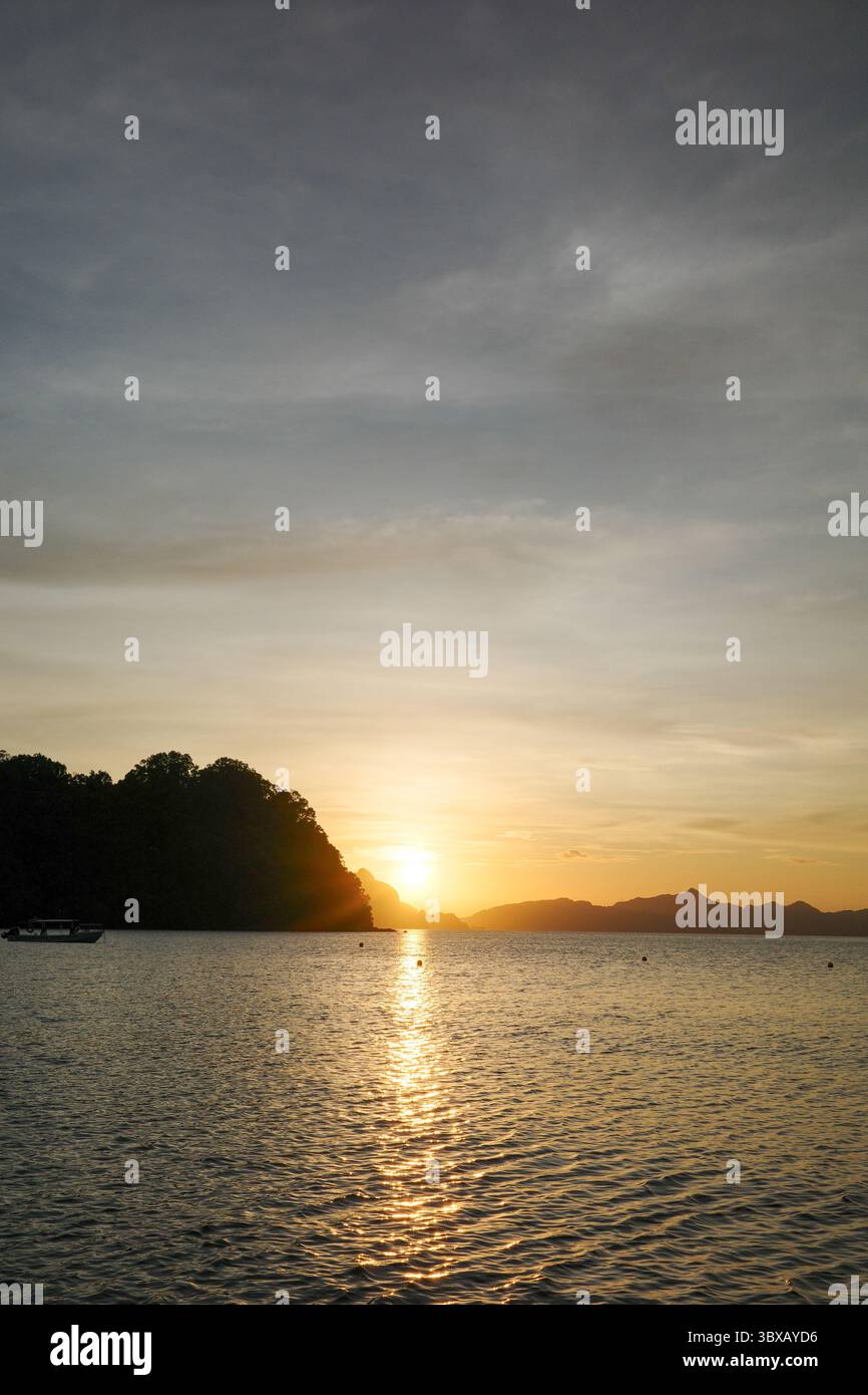 A beautiful sunset over the mountains in Vanilla beach, Coron, Palawan ...