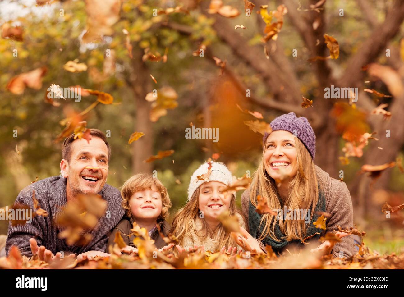 Happy family playing leaves hi-res stock photography and images - Alamy
