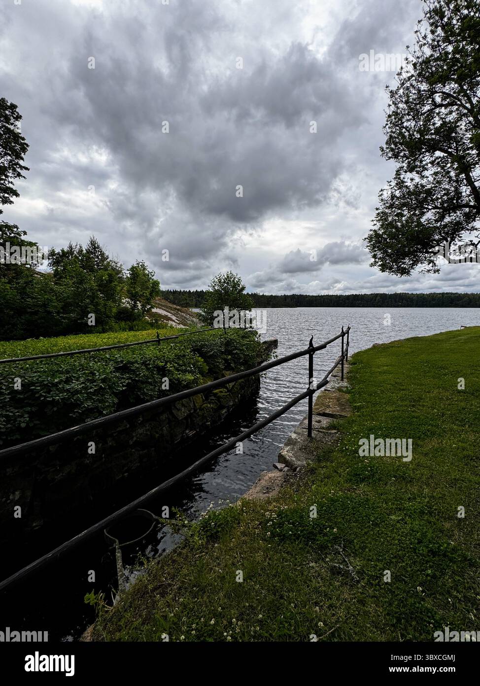 Canal and wrought iron fence near yellow manor house, Fagervik, Inkoo ...