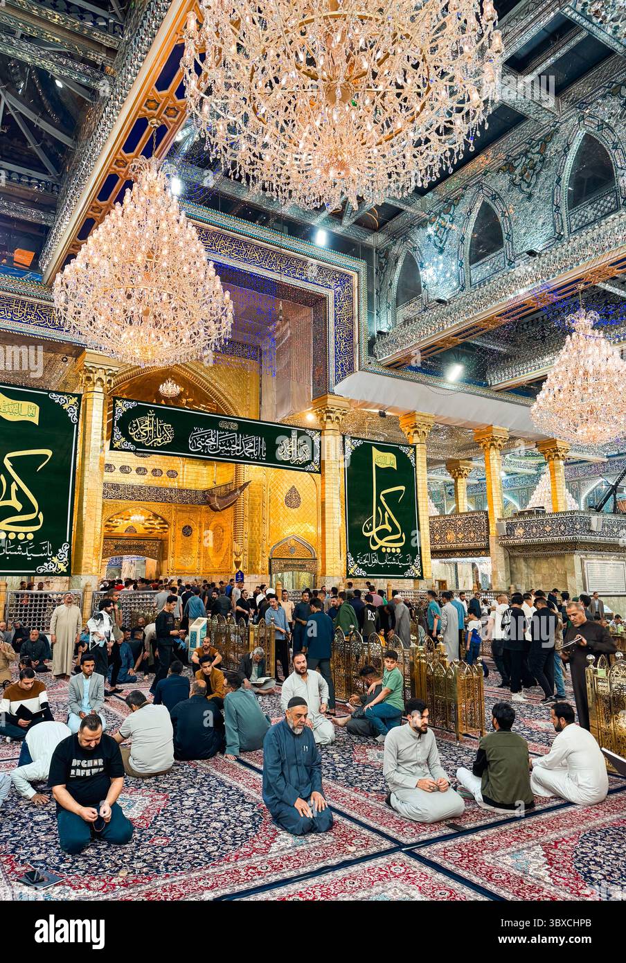 People gather in a beautiful shrine in Karbala, Iraq, engaging in prayer and reflection amidst ...