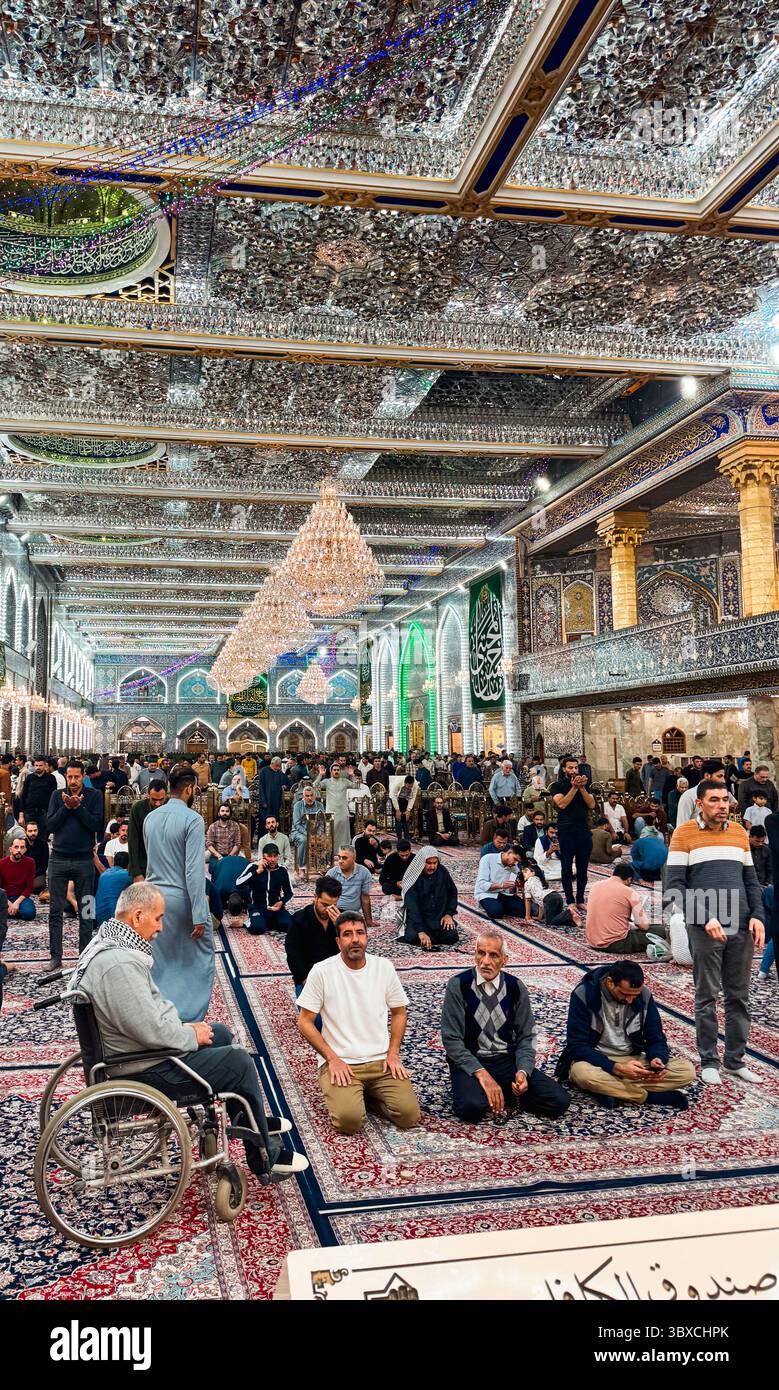 People gather in a beautifully adorned hall of the Imam Hussein shrine ...