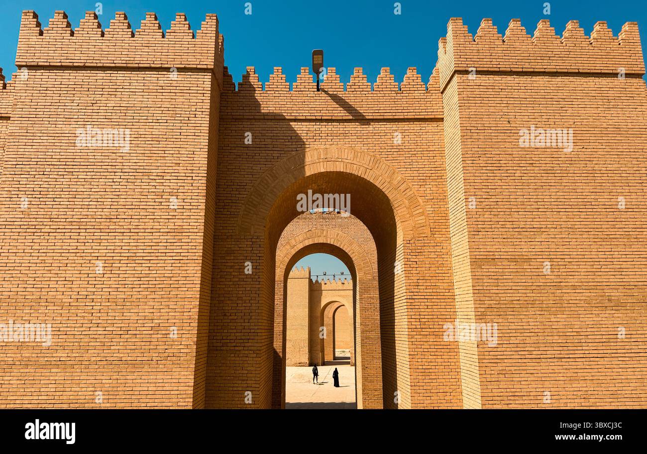 Visitors walk through the historical arches surrounded by ancient brick ...