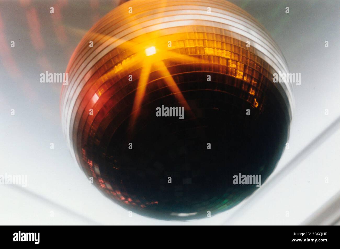 rotating disco ball that creates reflections around it Stock Photo - Alamy