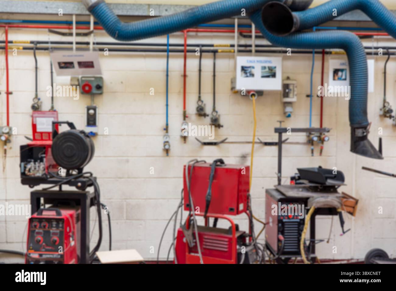 Central red welding machines are standing in flat design workshop, with ...