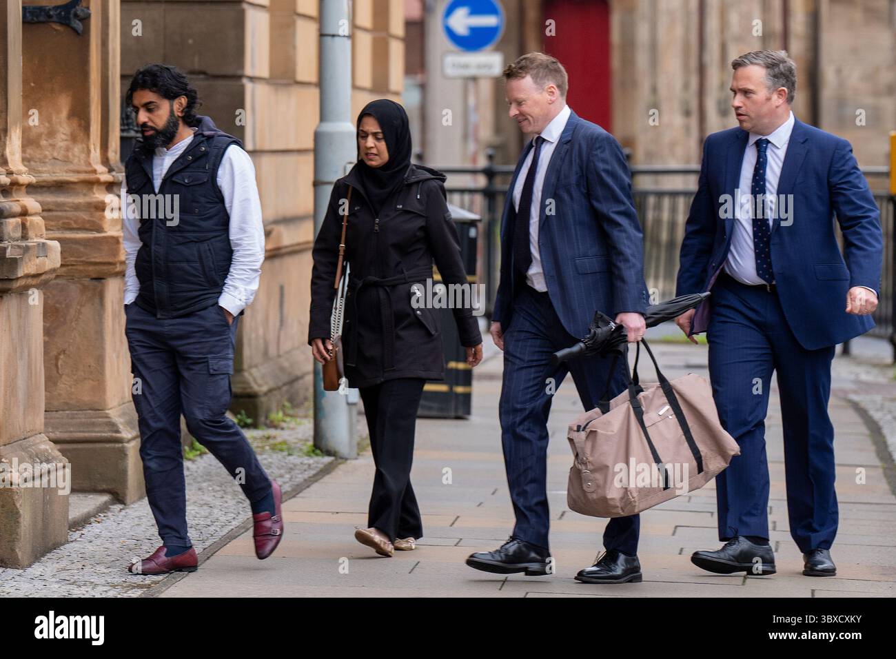 Attiya Sheikh (second left) and her husband Omer Sheikh (left), along ...