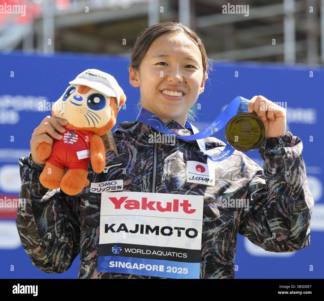 Ichika Kajimoto of Japan shows off her medal after winning bronze in the women's 5-kilometer ...