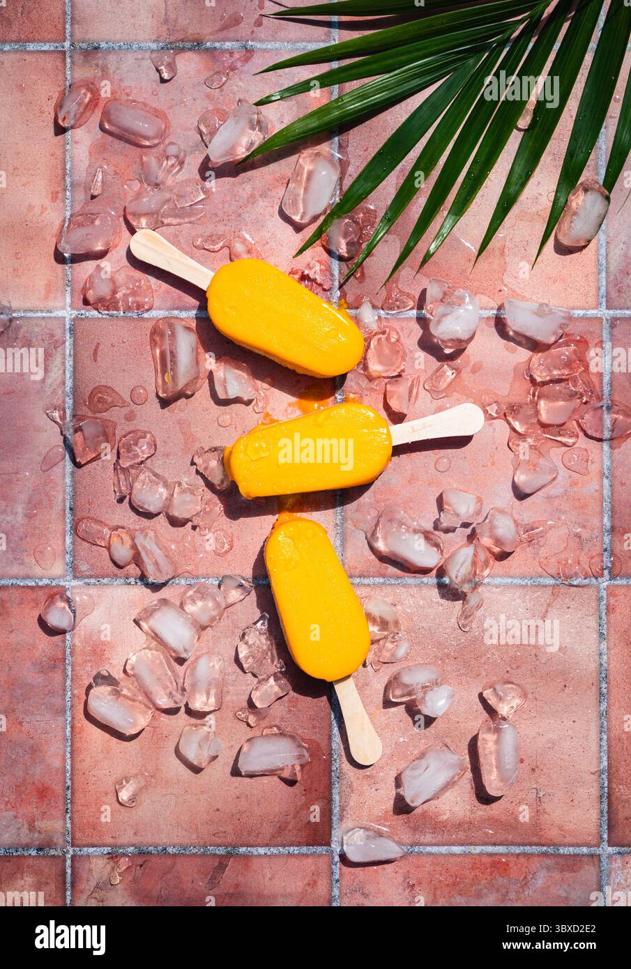 Top view of mango popsicles on terra cotta tile in the sun Stock Photo ...
