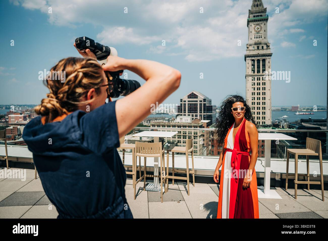 Photographer captures model in red dress on sunny Boston rooftop Stock ...