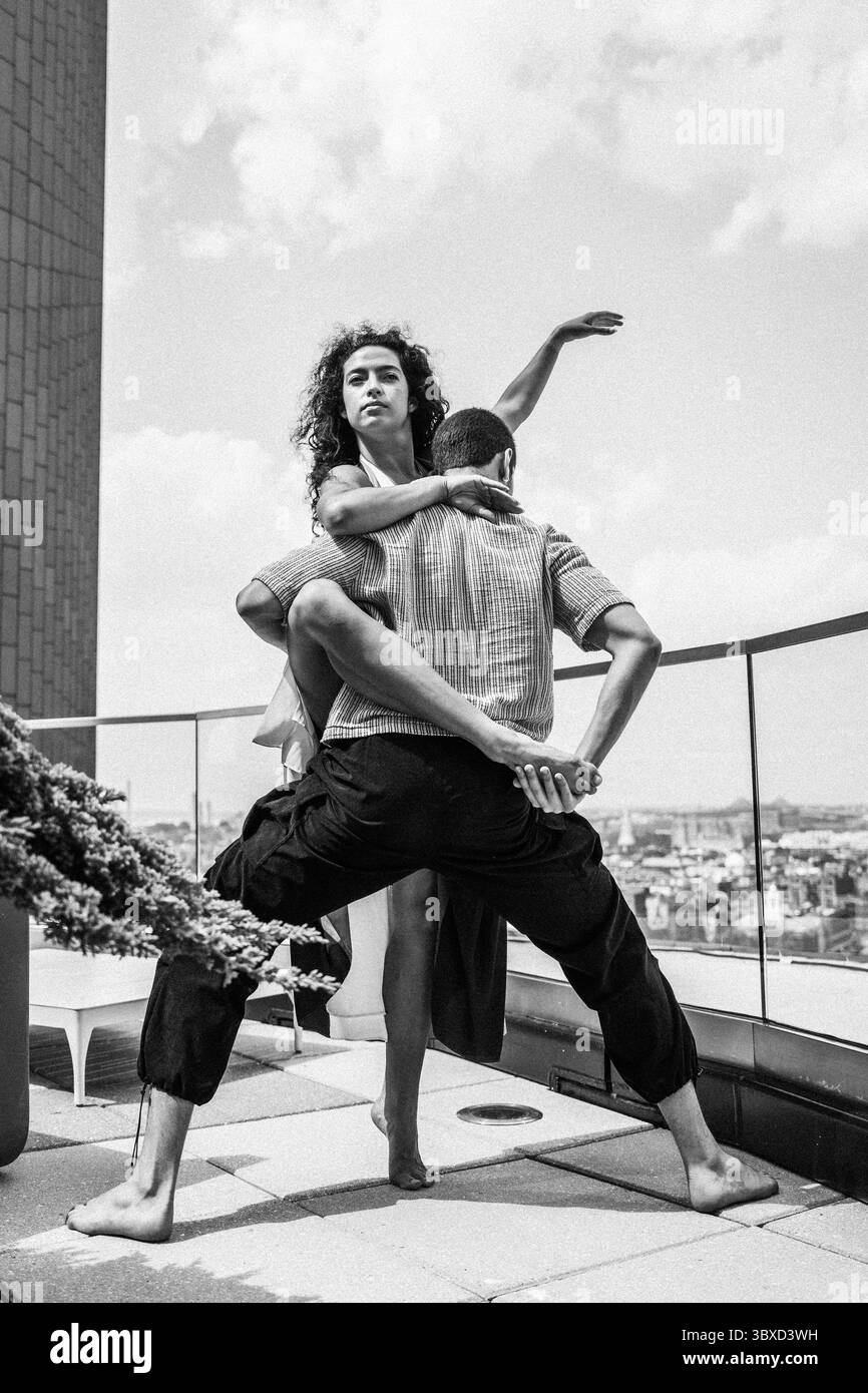 Dancers hold powerful rooftop pose in black-and-white Boston scene ...