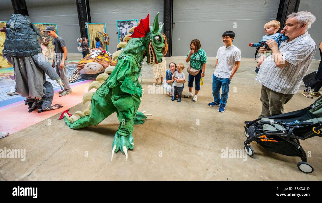 London, UK. 18 Jul 2025. A smoke breathing dragon 'slowly' chases the ...