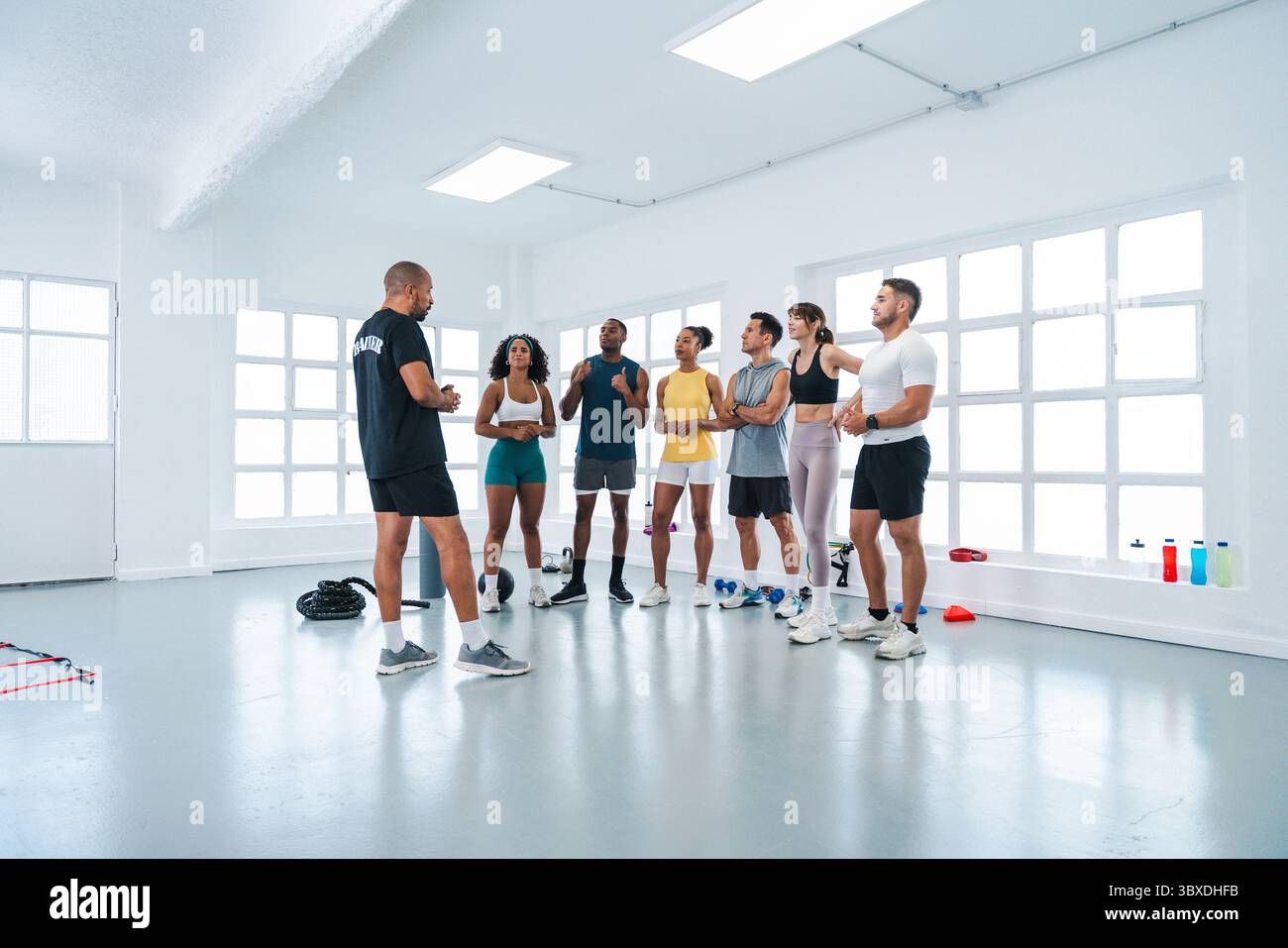 Multiethnic group of sportive people doing functional workout in ...
