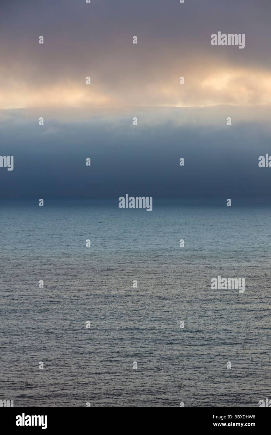 Lifting clouds and fog over the Pacific Ocean, dusk, Oswald West State ...