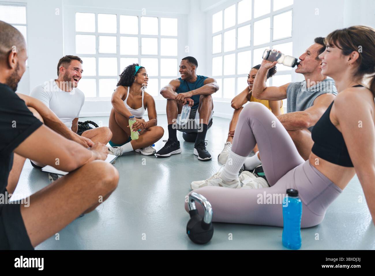 Multiethnic group of sportive people doing functional workout in ...