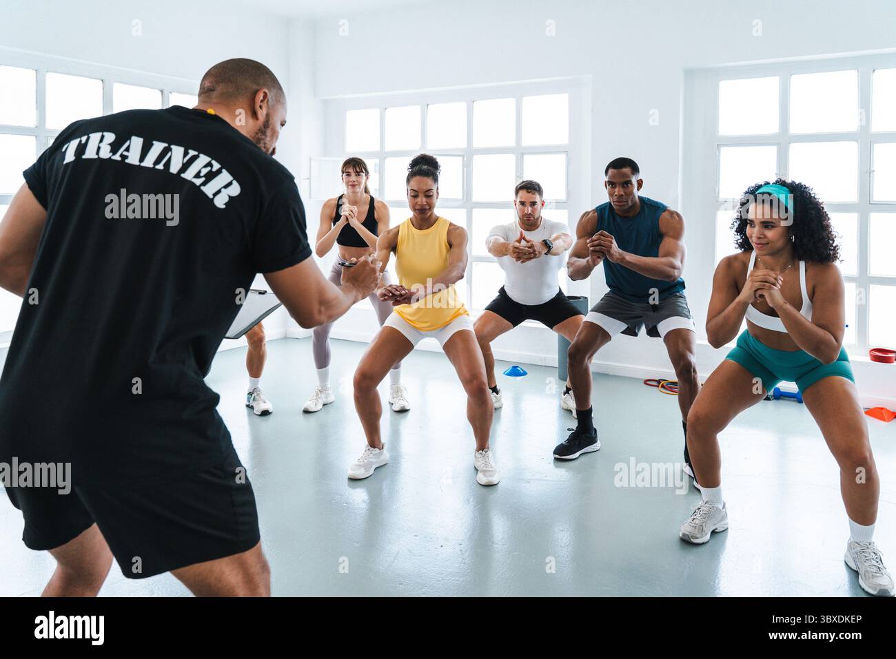 Multiethnic group of sportive people doing functional workout in ...