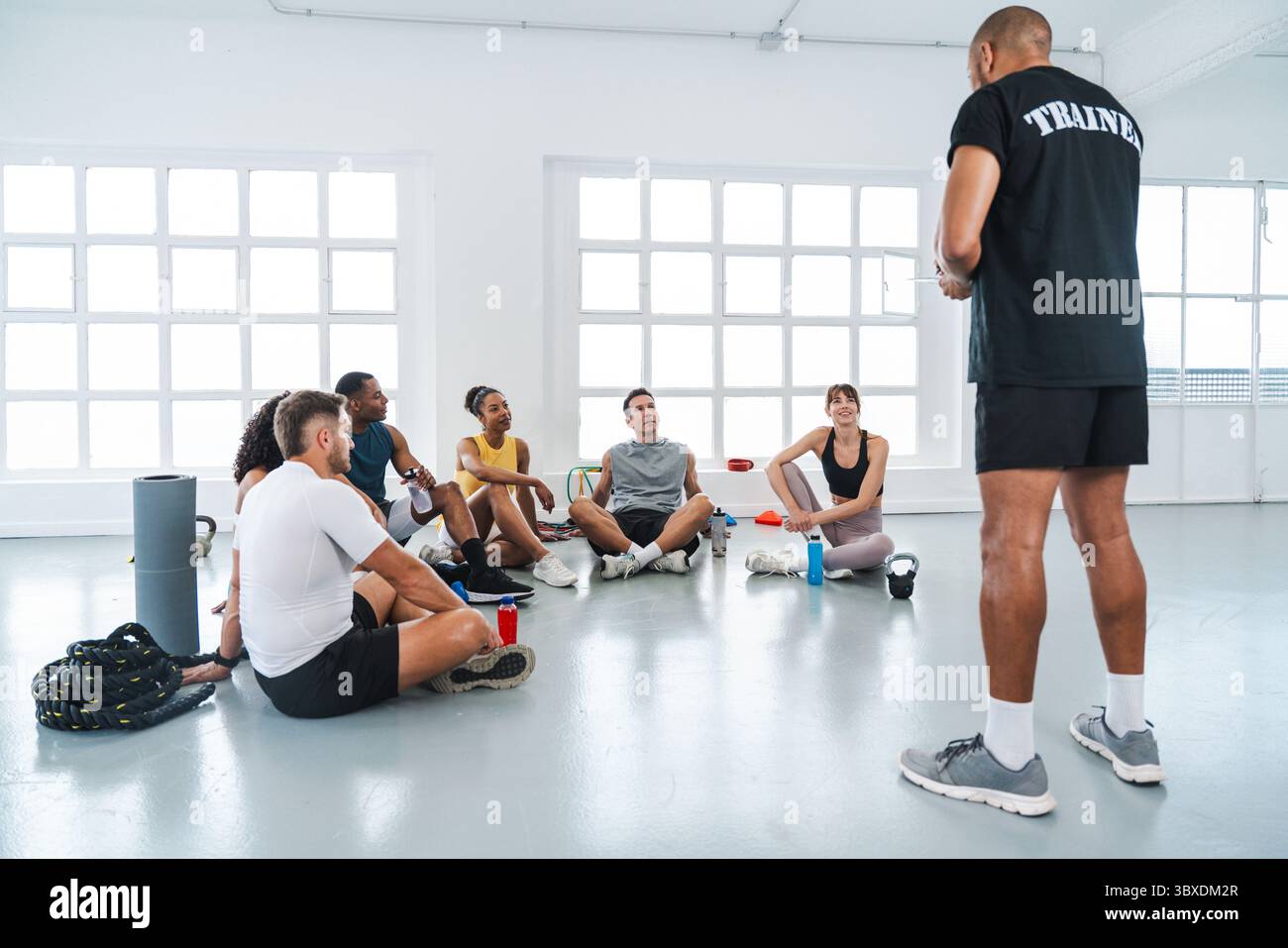 Multiethnic group of sportive people doing functional workout in ...