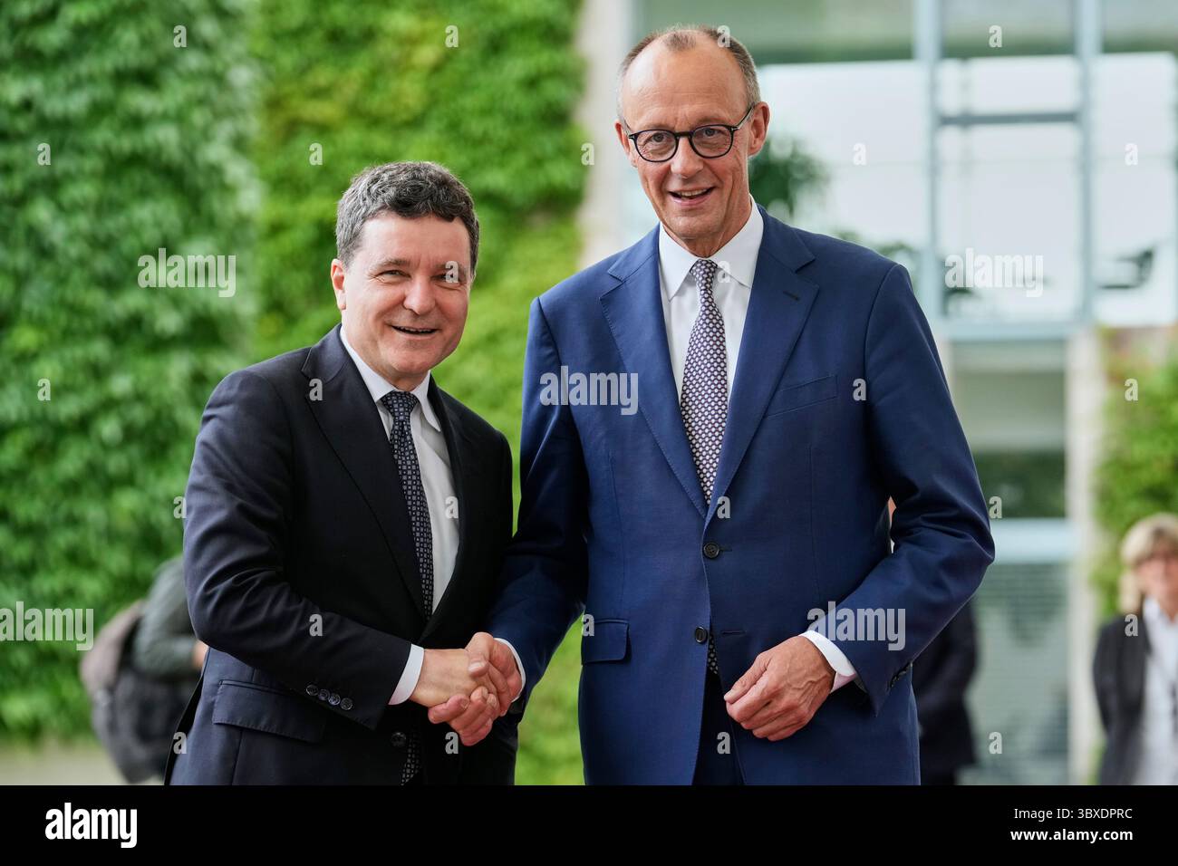 German Chancellor Friedrich Merz, right, welcomes Romania's President ...