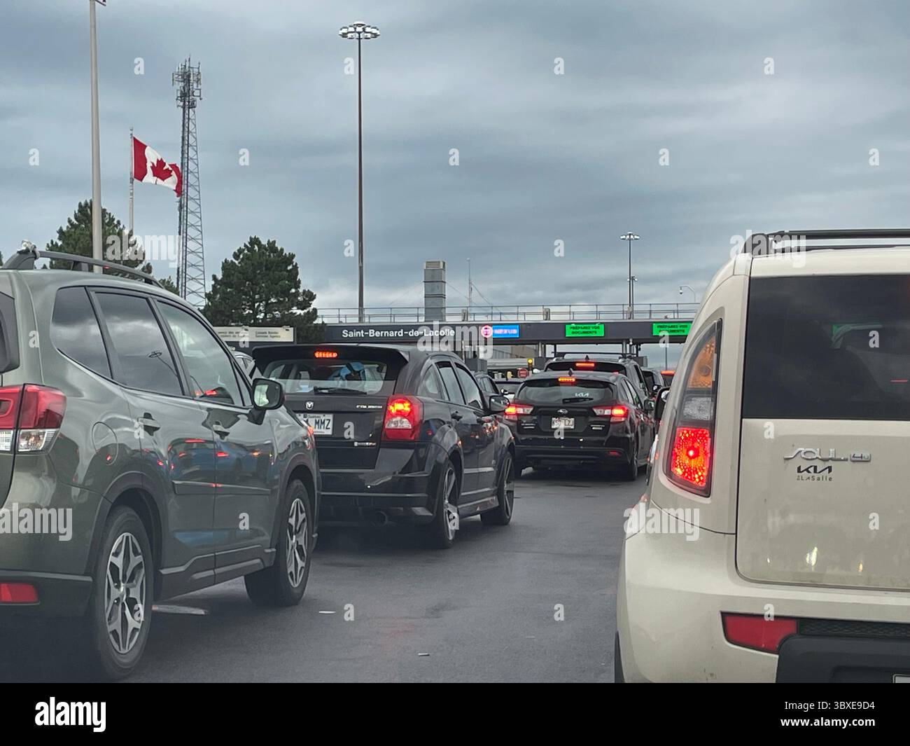 Drivers sit and wait their turn at the international border crossing ...