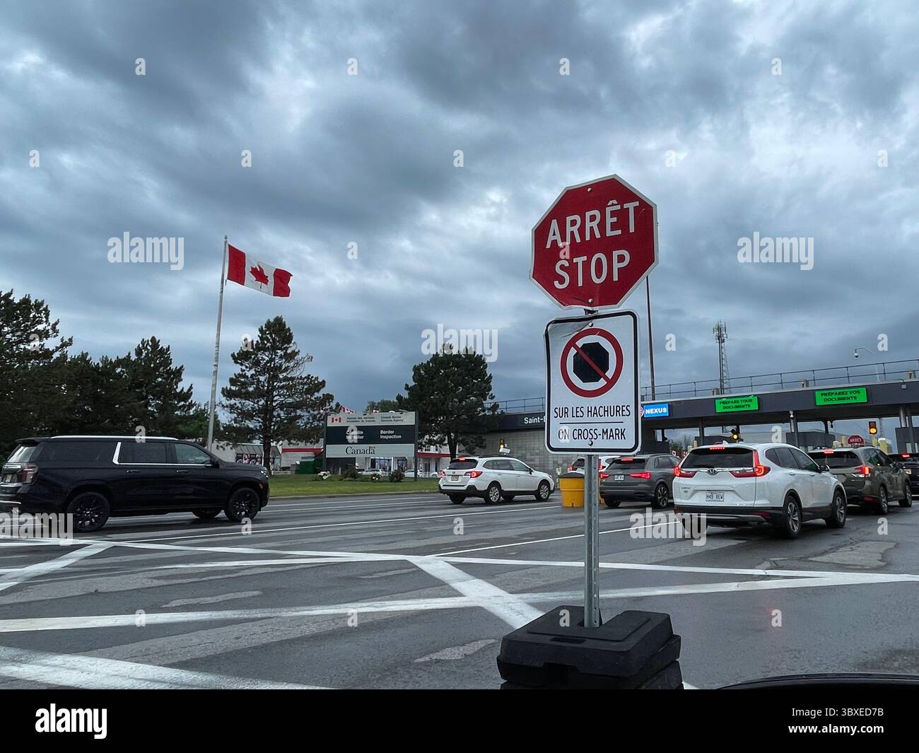A stop sign in English and French requests drivers stop before ...
