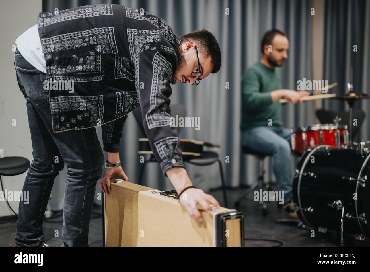 Two musicians engaging in a studio rehearsal session, fine-tuning their ...