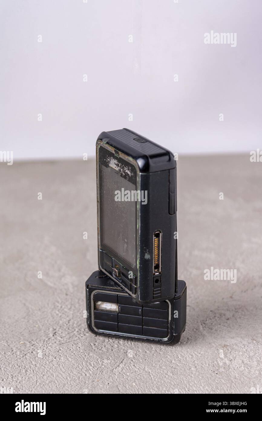 Old broken mobile phone with rotary keyboard on gray plaster Stock ...