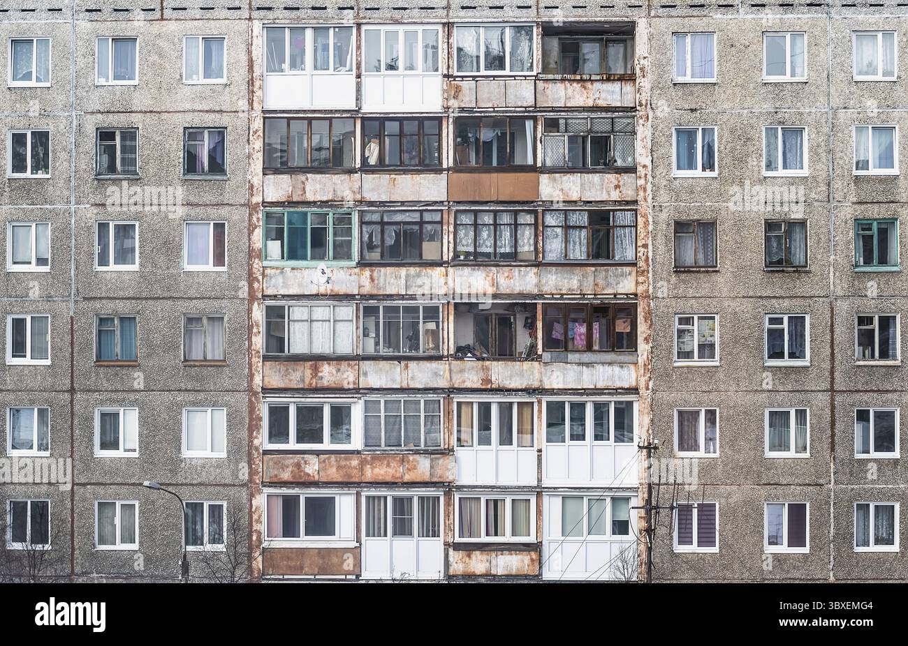 Facade of a grey multi-storey soviet panel building. Russian old urban ...