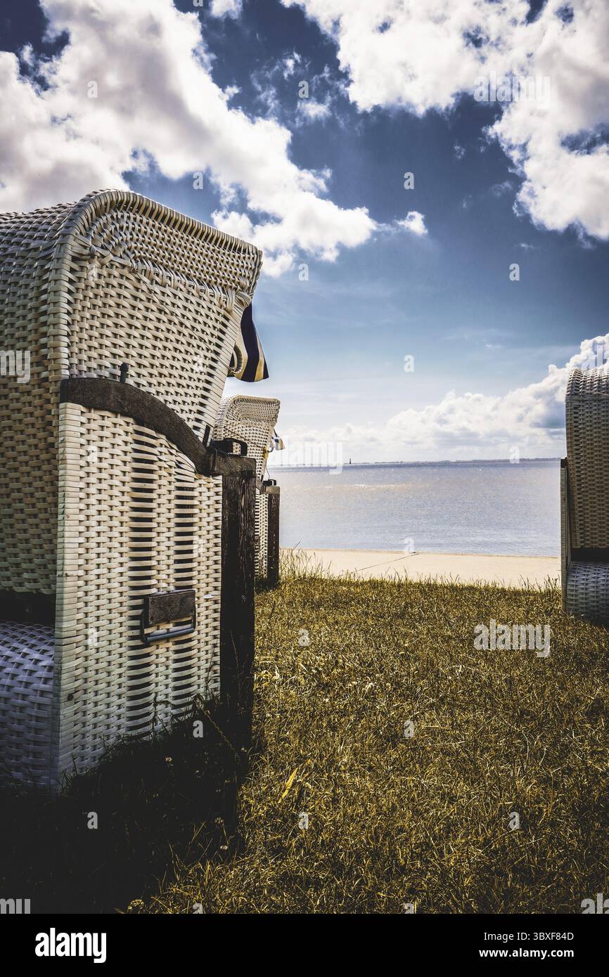Beach chairs on the shore with a view of the North Sea or Jade Bay ...