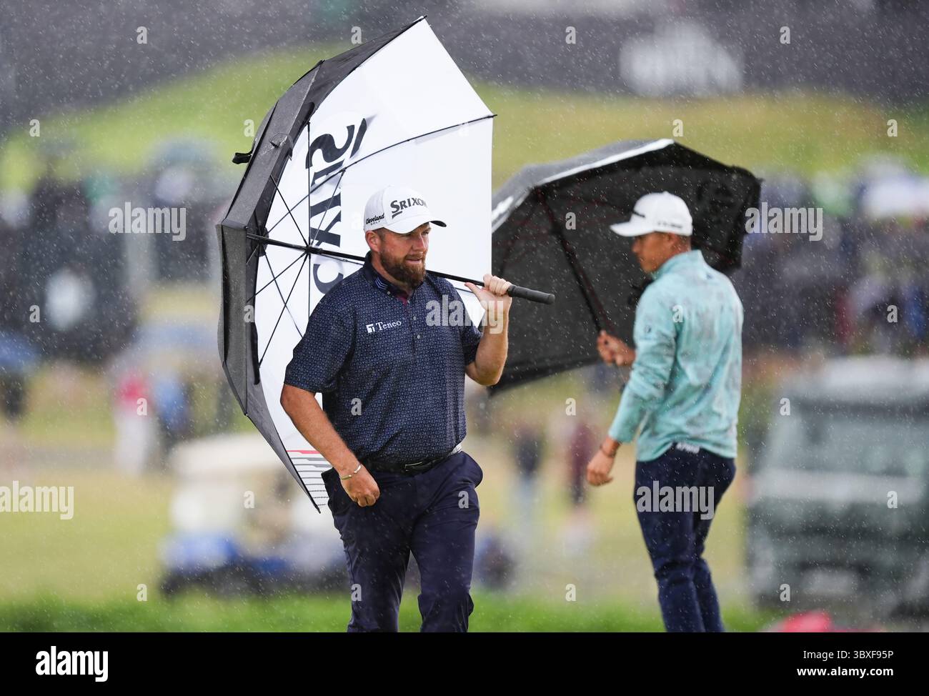 Ireland's Shane Lowry shelters from the rain on day two of The 153rd ...