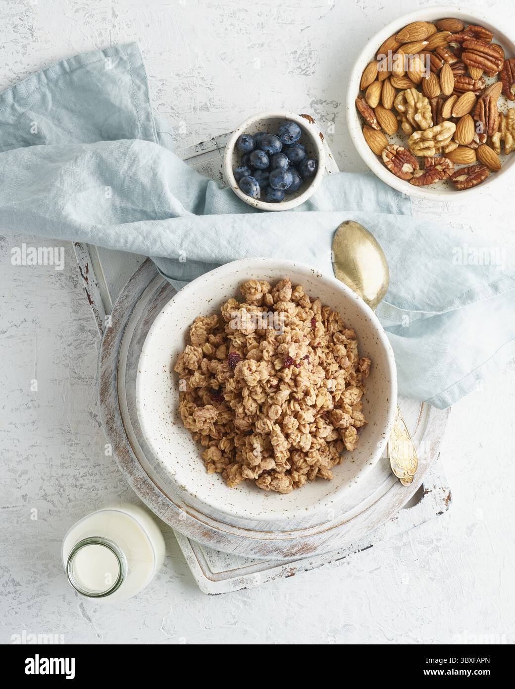 Dry granola in bowl. Breakfast, healthy diet food with milk in bottle ...
