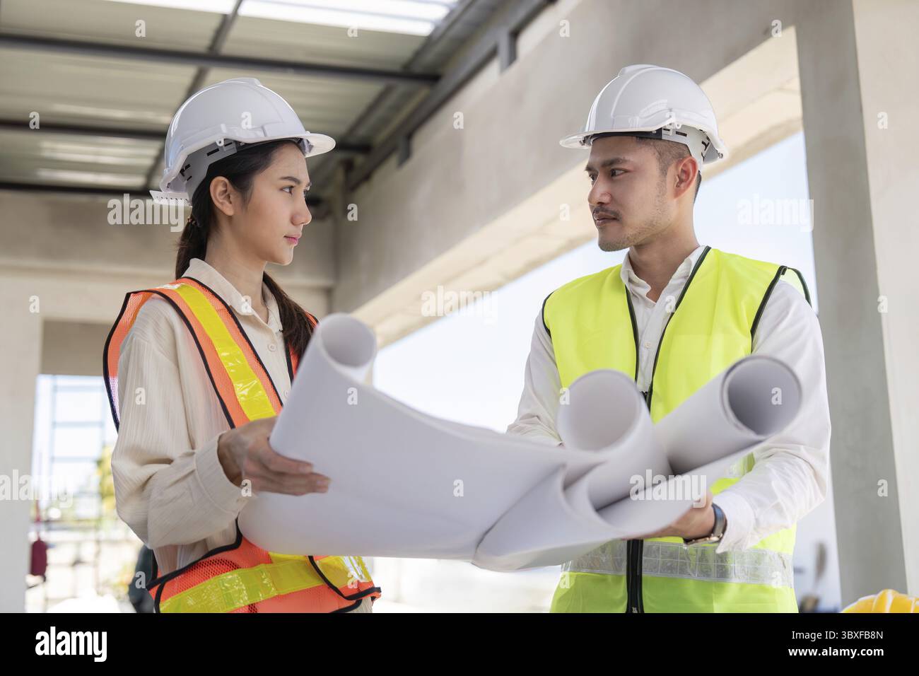 Two engineers reviewing construction hi-res stock photography and ...