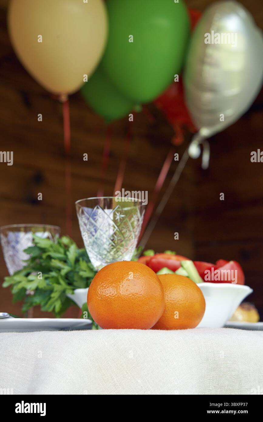 Table full of chopped vegetables and fruits colorful air balloons on ...