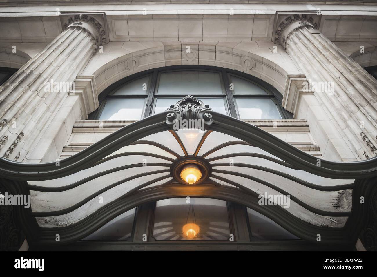 Facade of a building with columns above a canopy at the entrance of a ...