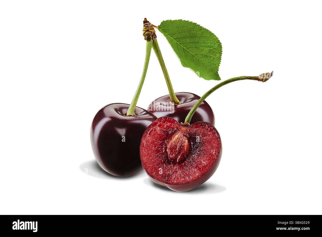 Two whole dark red sweet cherries with green leaf and one cutted in ...