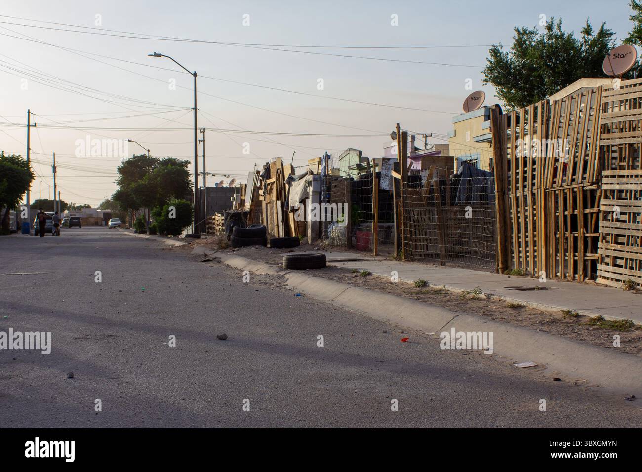 Makeshift barriers line a street in Ciudad Juarez, reflecting urban ...