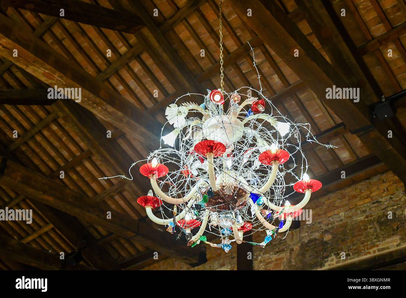 Murano glass chandelier wrapped in barbed wire, art installation by ...