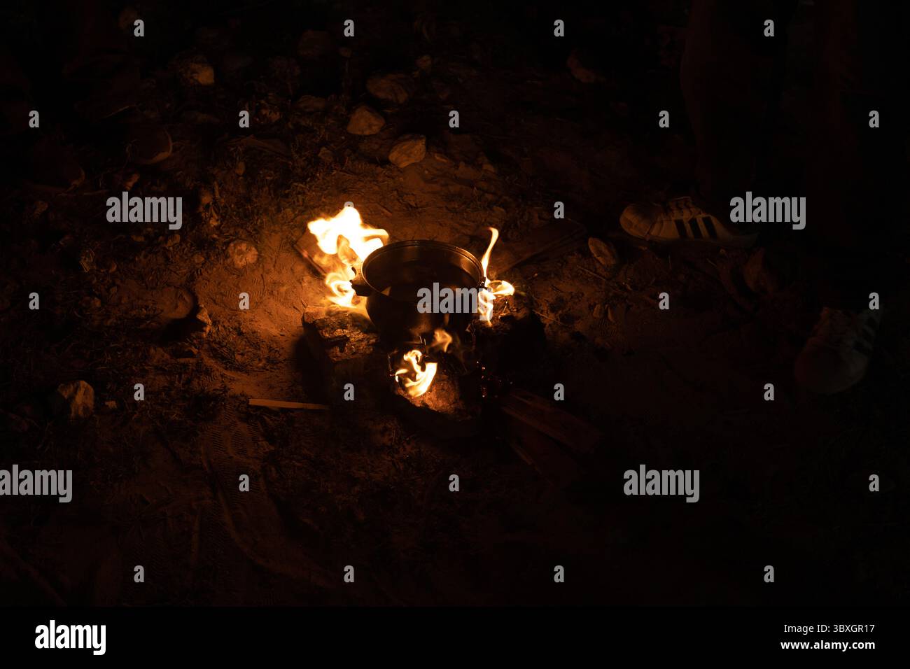 Amidst poverty in Ciudad Juarez, people huddle around a fire, cooking ...