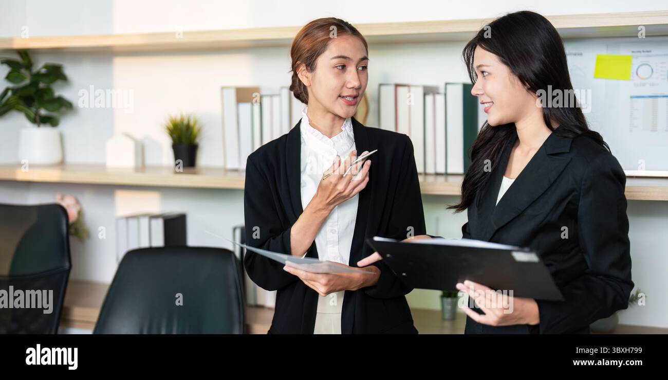 Effective Communication. Two women discussing business strategies in a ...