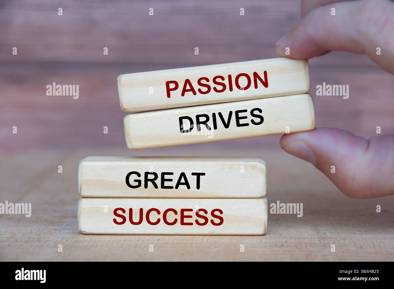 Hand holding wooden blocks with Passion Drives Great Success text on ...