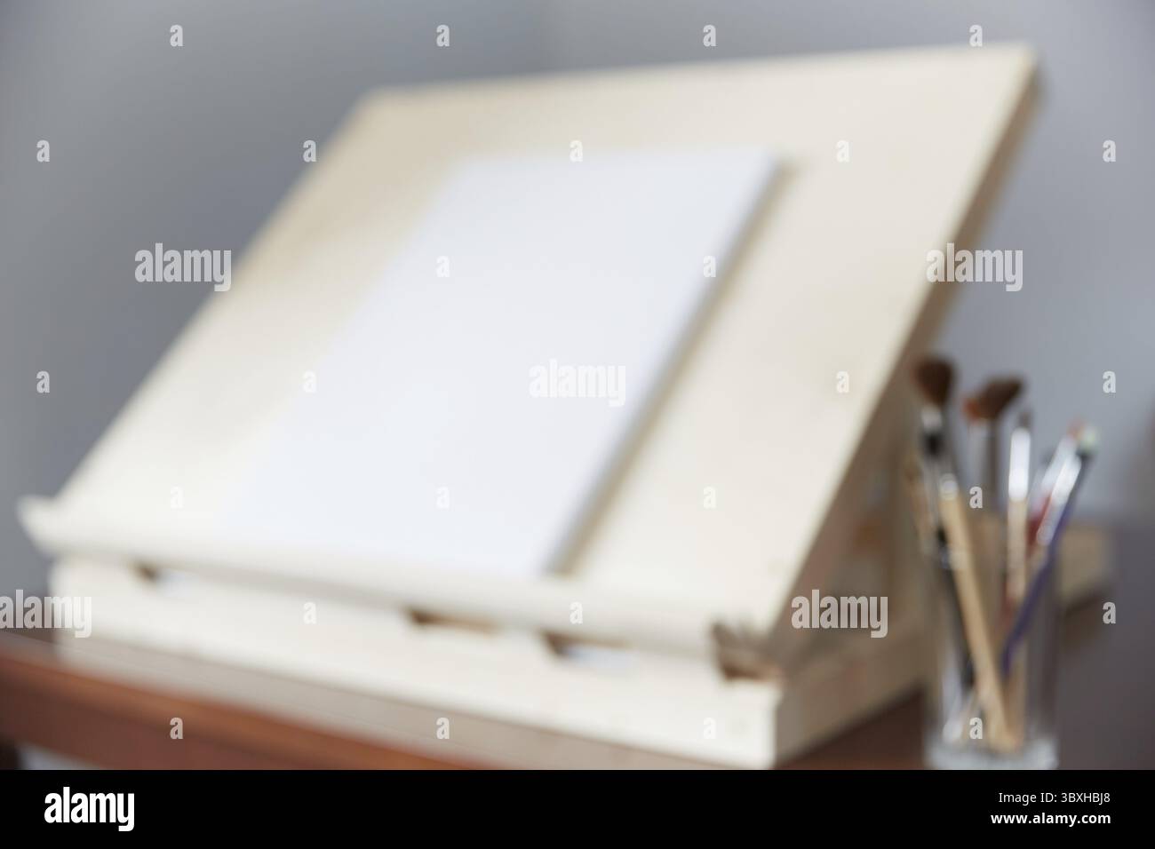 Easel is out of focus. background for a text on teaching drawing in an ...