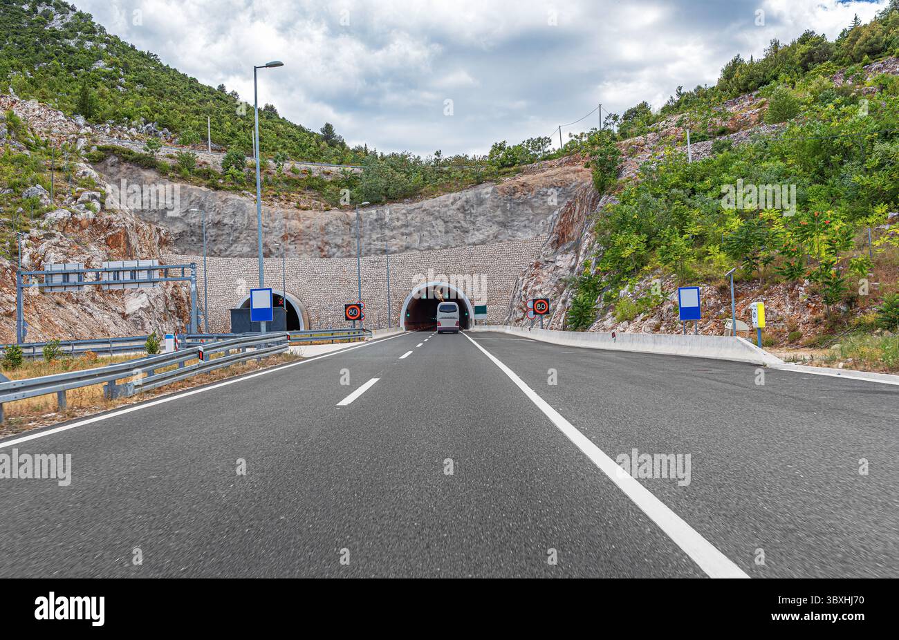 A modern highway approaches the entrance of a road tunnel Stock Photo ...