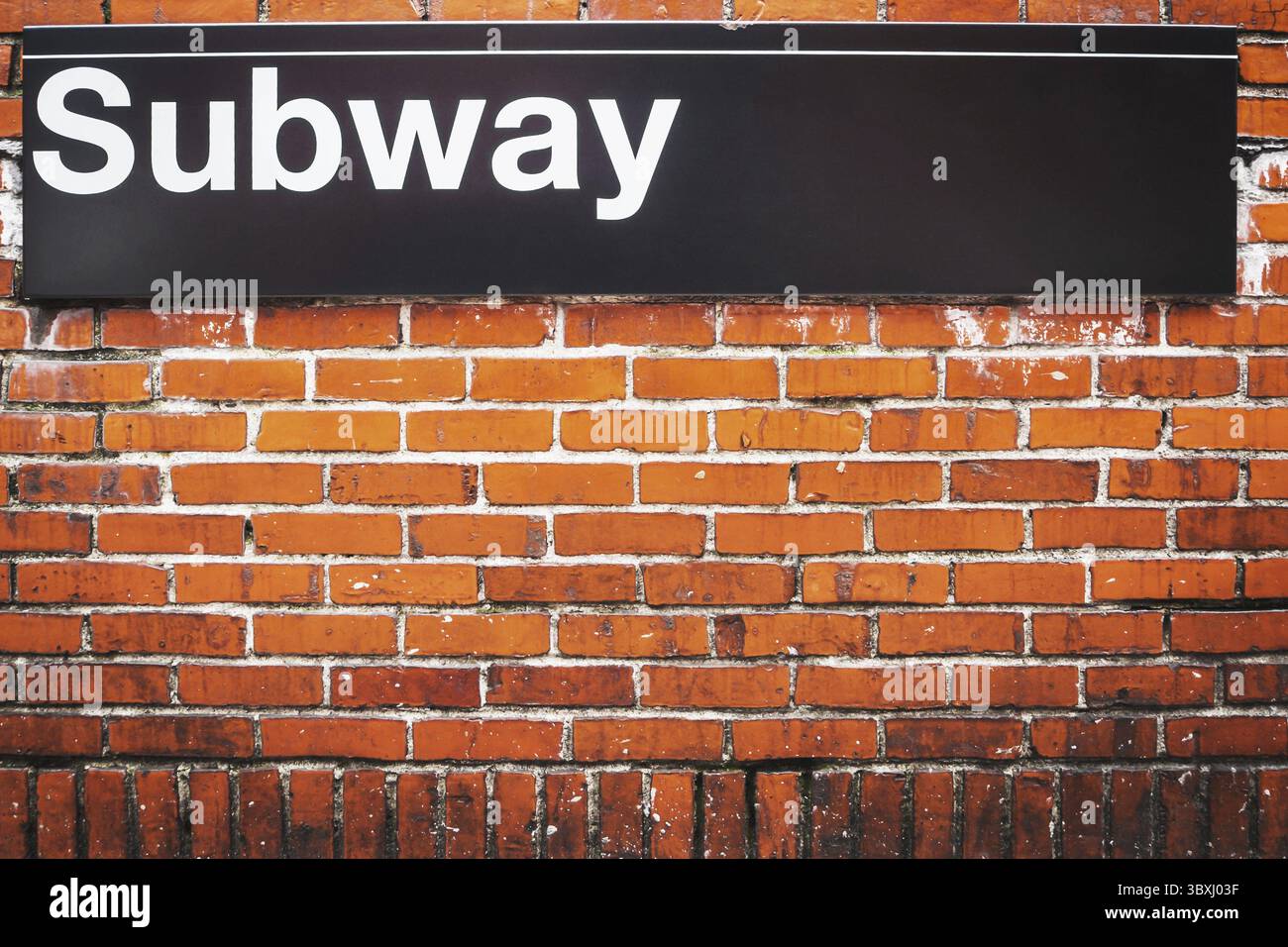 Subway sign of metro access on a red brick wall in New York City Stock ...
