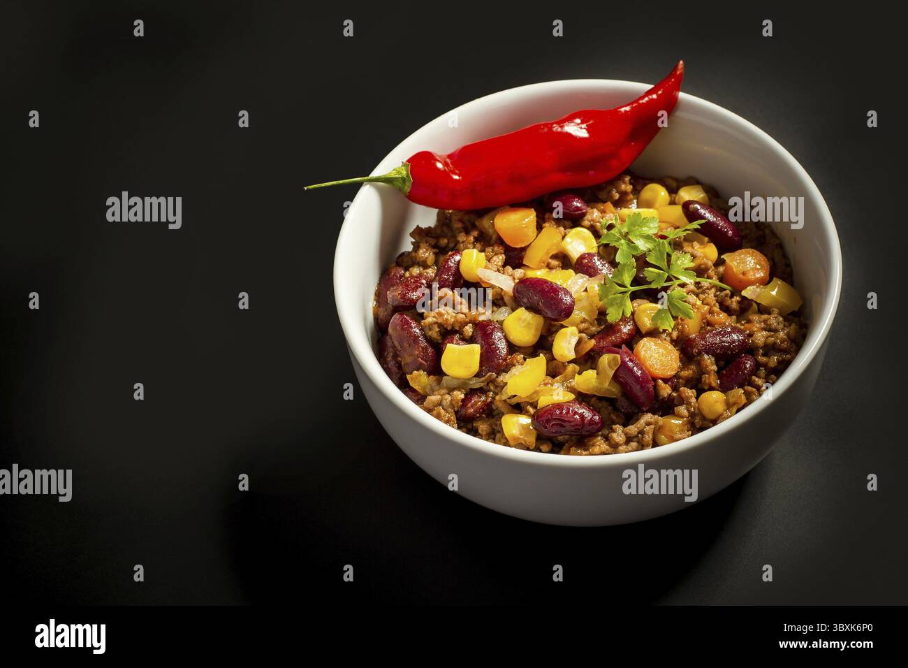 Chili con Carne on black, top view Stock Photo - Alamy