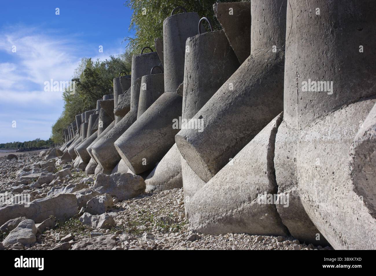 Beach fortified with boulders Stock Photo - Alamy