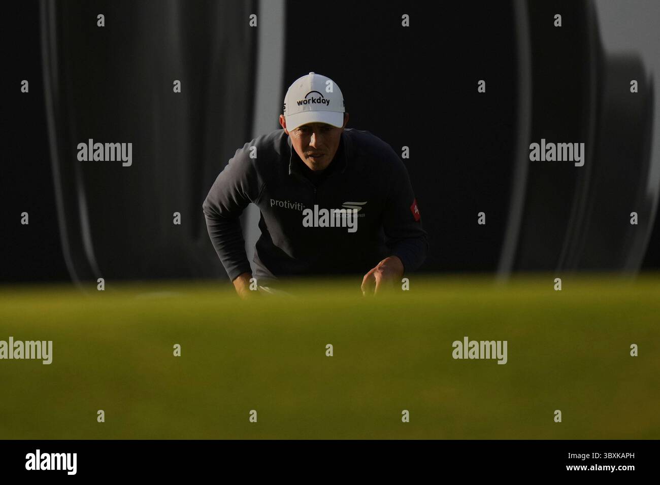 Matt Fitzpatrick of England looks at his putt on the 18th green during ...
